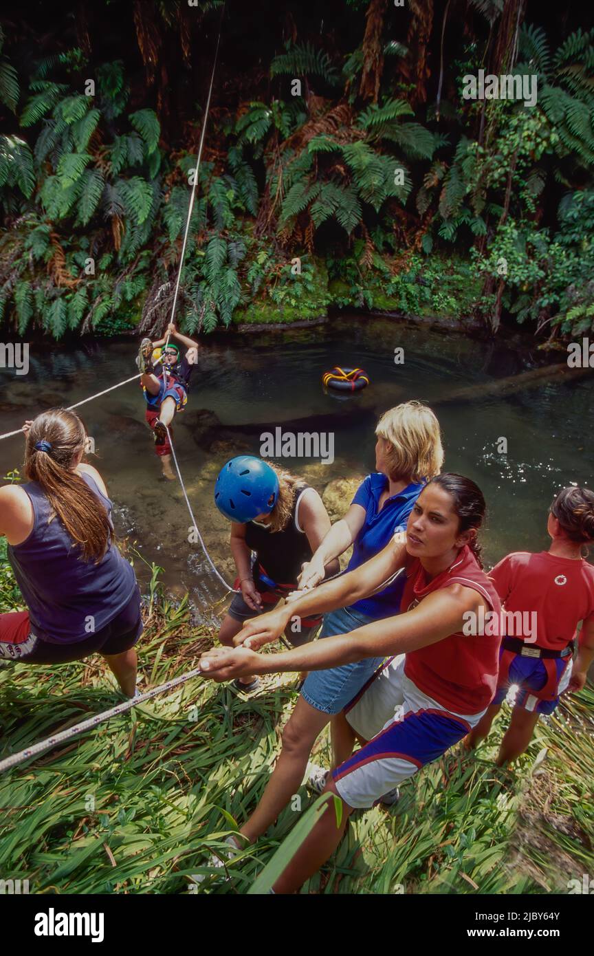 Team building using ropes to cross river Stock Photo - Alamy