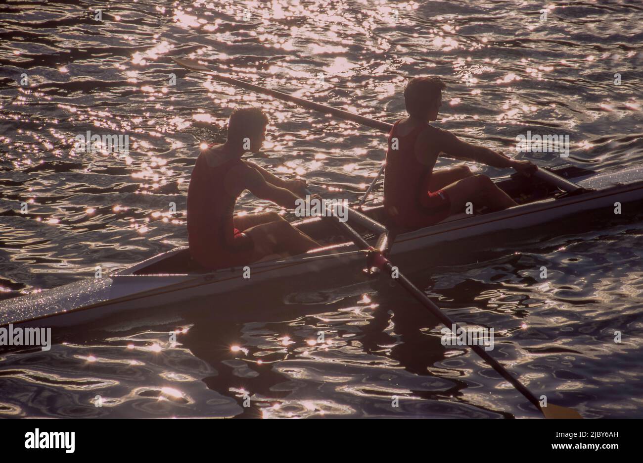 Two men rowing in double scull on water Stock Photo - Alamy