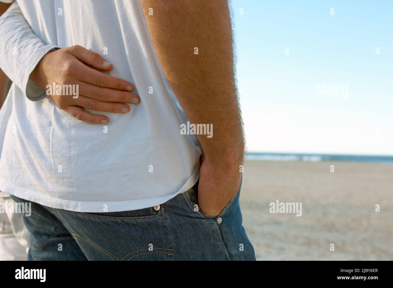 Mans arm around woman hi-res stock photography and images - Alamy