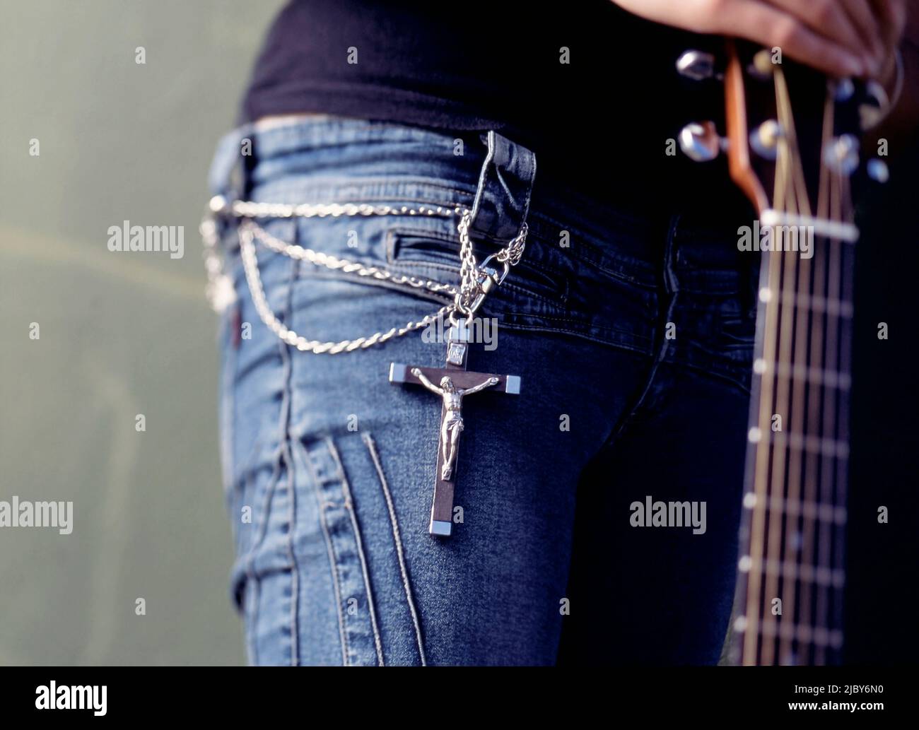 Mid section of young woman wearing a crucifix and chain around her ...