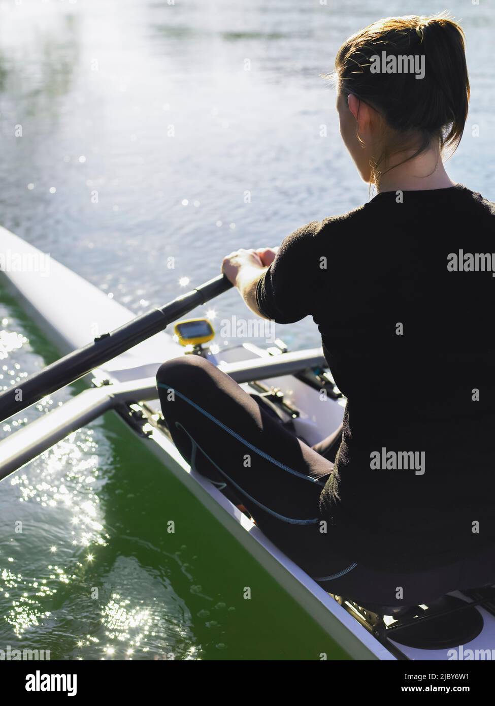 Back close up view of female rower on the water Stock Photo - Alamy