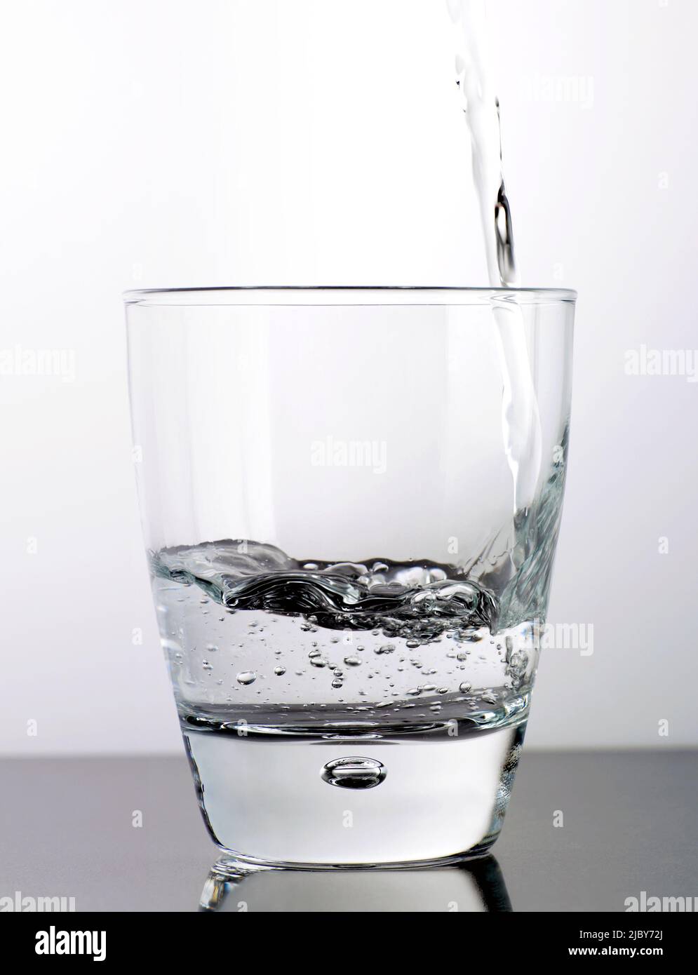 Water being poured into a glass Stock Photo - Alamy