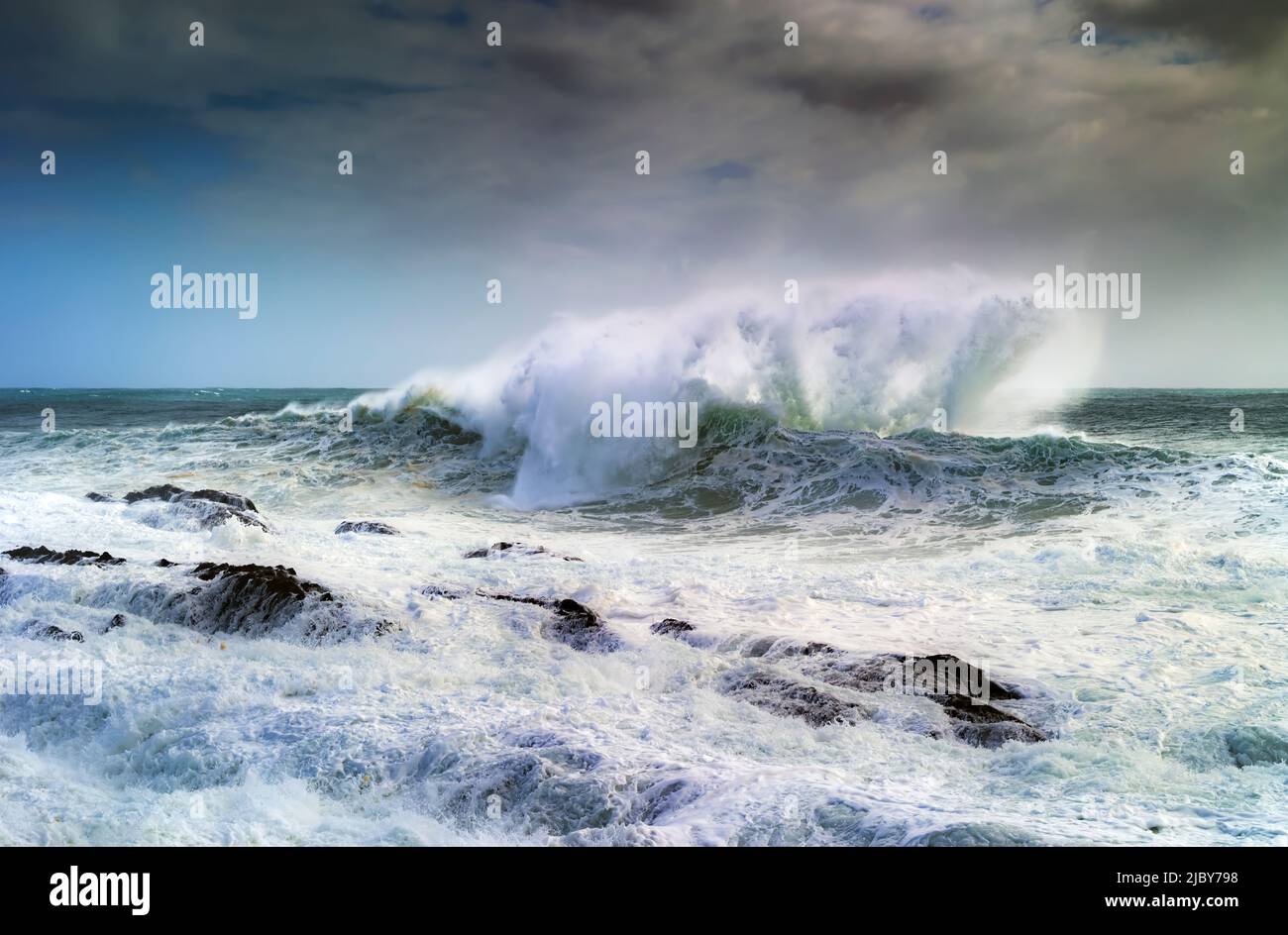 Huge wave curling over and breaking during cyclone Ola with stormy sky ...