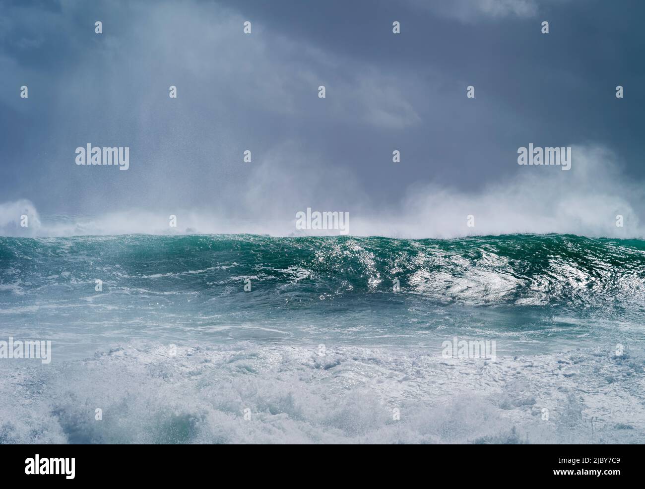 Wave curling over and breaking during cyclone Ola with stormy sky Stock ...