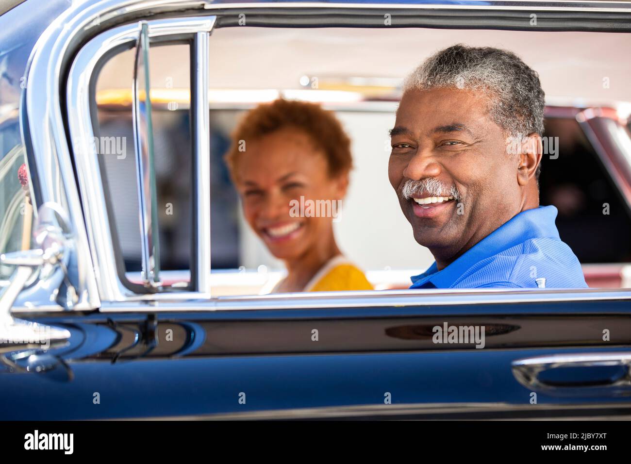 Older couple sitting in a classic car looking to camera smiling Stock ...