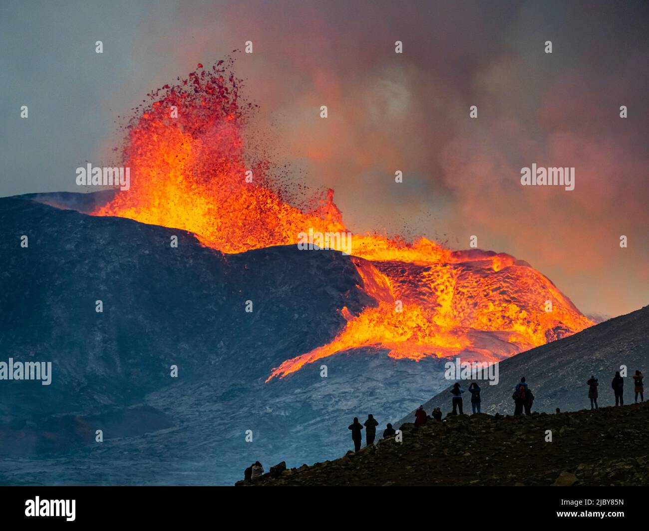 Hikers enjoy fireworks from Observation Hill as glowing lava is ejected ...