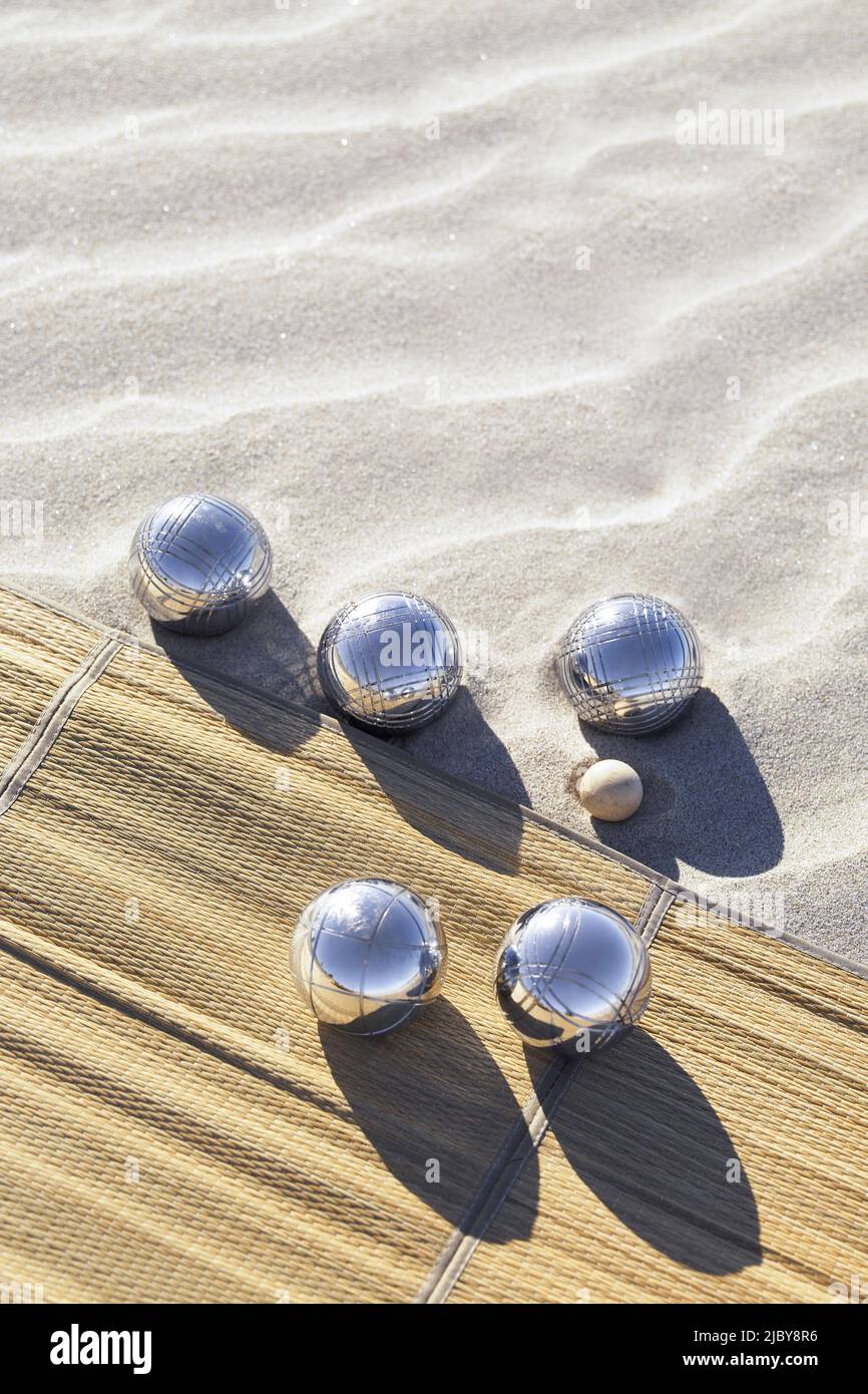 Petanque balls on grass mat and sand at the beach Stock Photo - Alamy