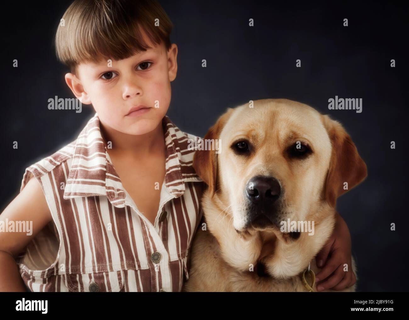 Portrait of little boy cuddling his big dog Stock Photo - Alamy