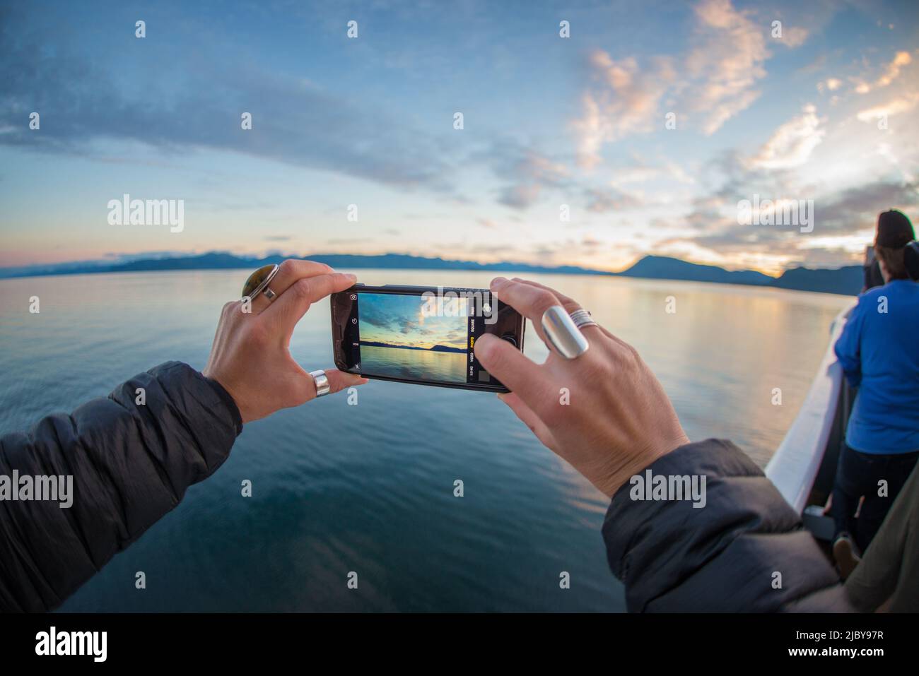 Taking photo of sunset with phone Stock Photo - Alamy