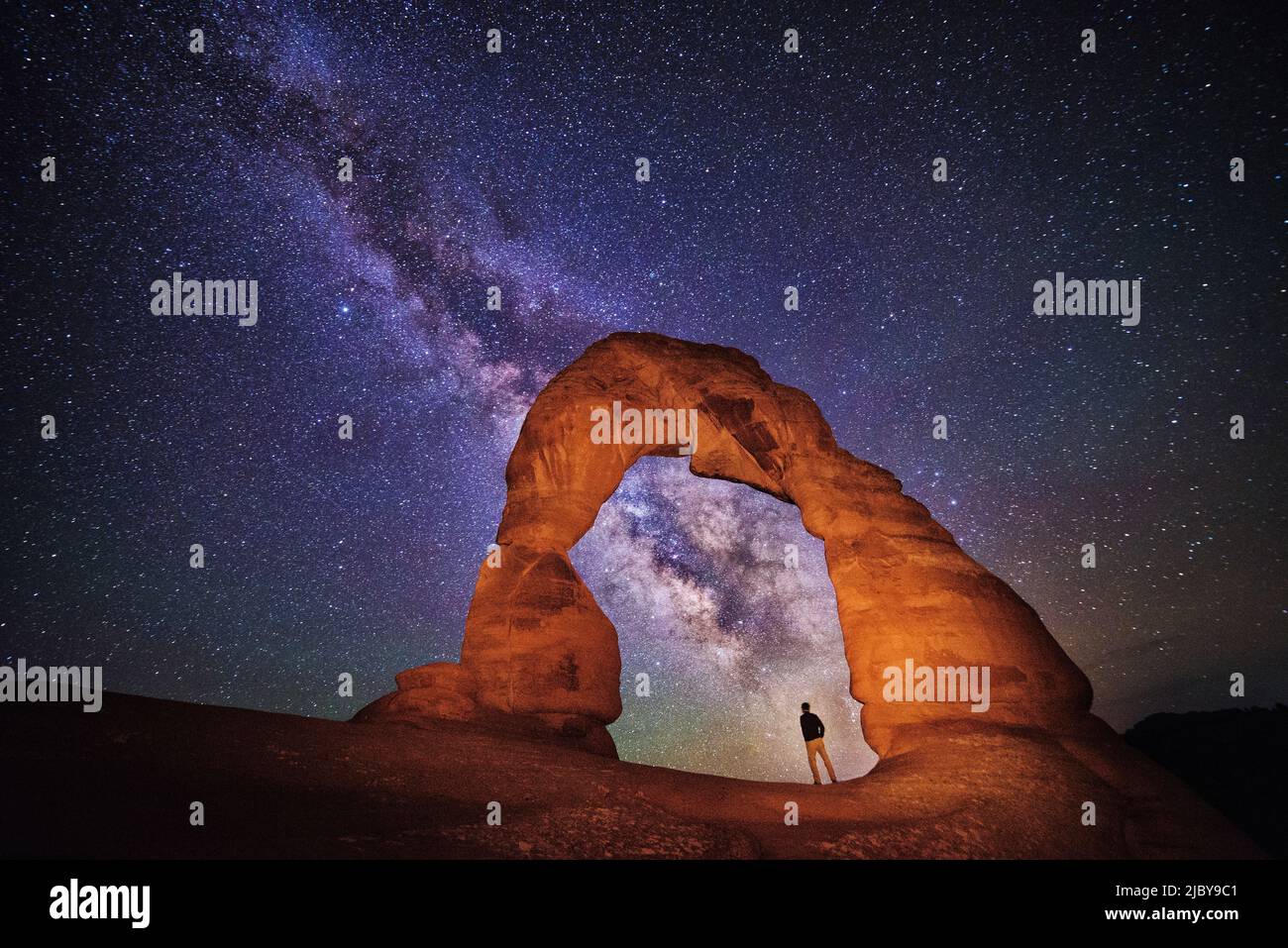 Portrait under delicate arch with the milky way, Arches National Park ...