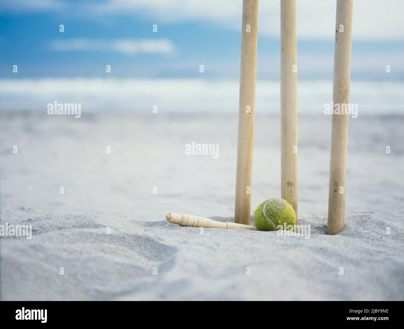 Wooden cricket stumps and tennis ball on the beach Stock Photo - Alamy