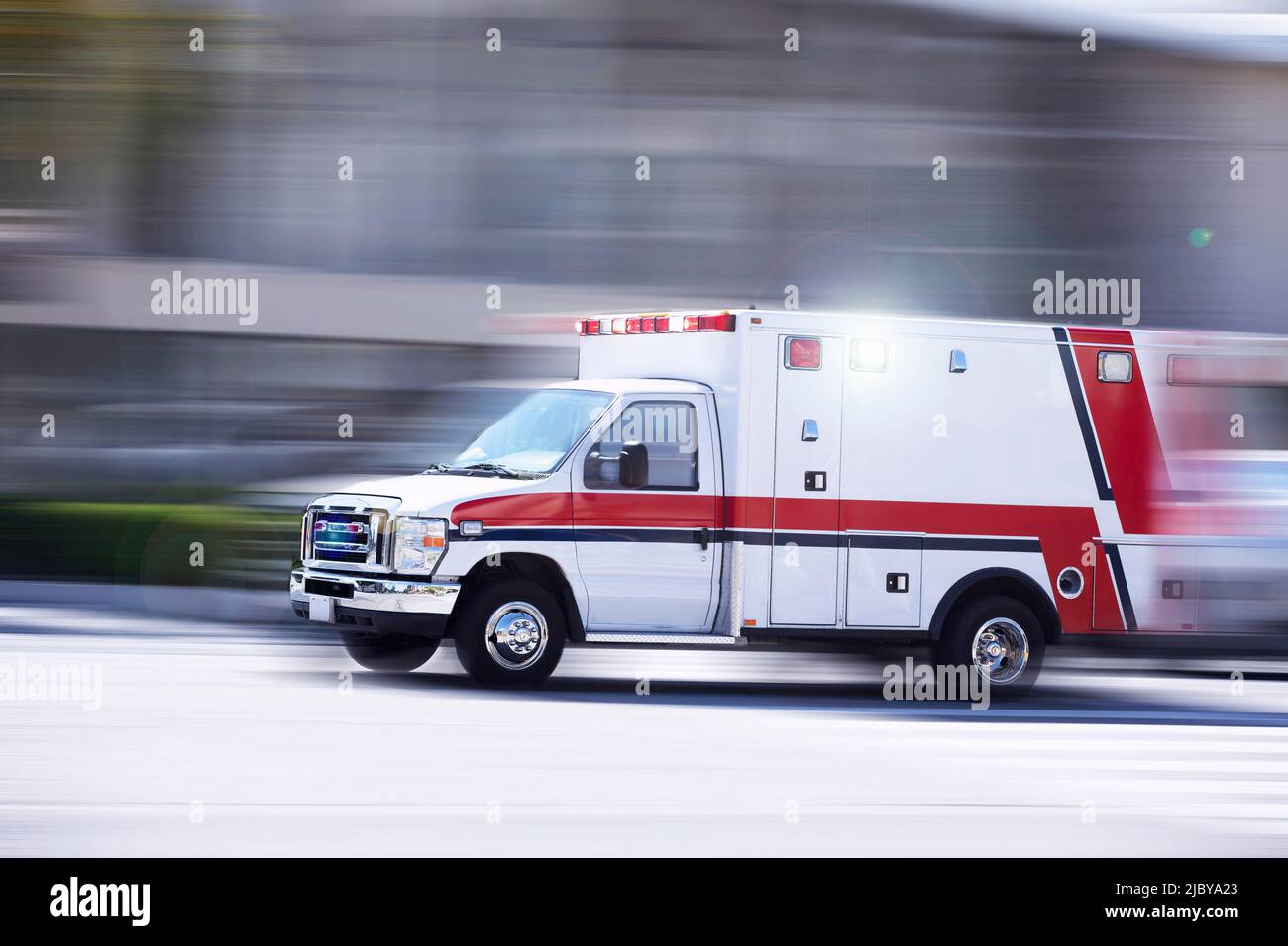Blurred motion action view of an ambulance responding to the scene of ...