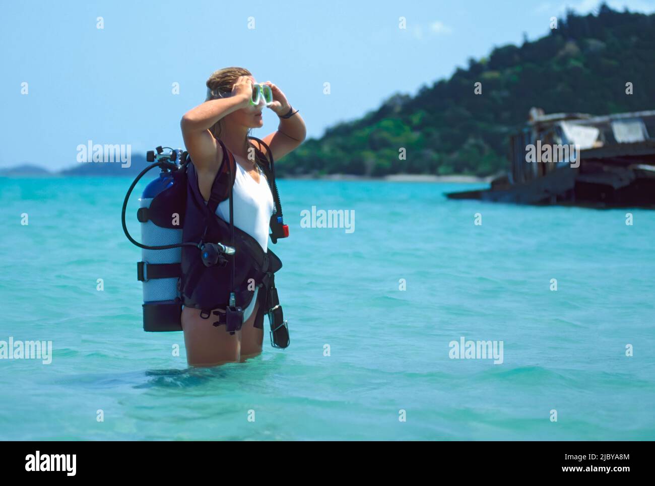Young woman standing in water wearing scuba diving gear Stock Photo - Alamy