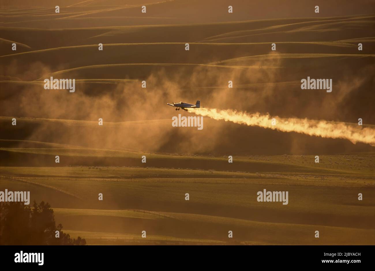 Small plane topdressing farmland Stock Photo - Alamy