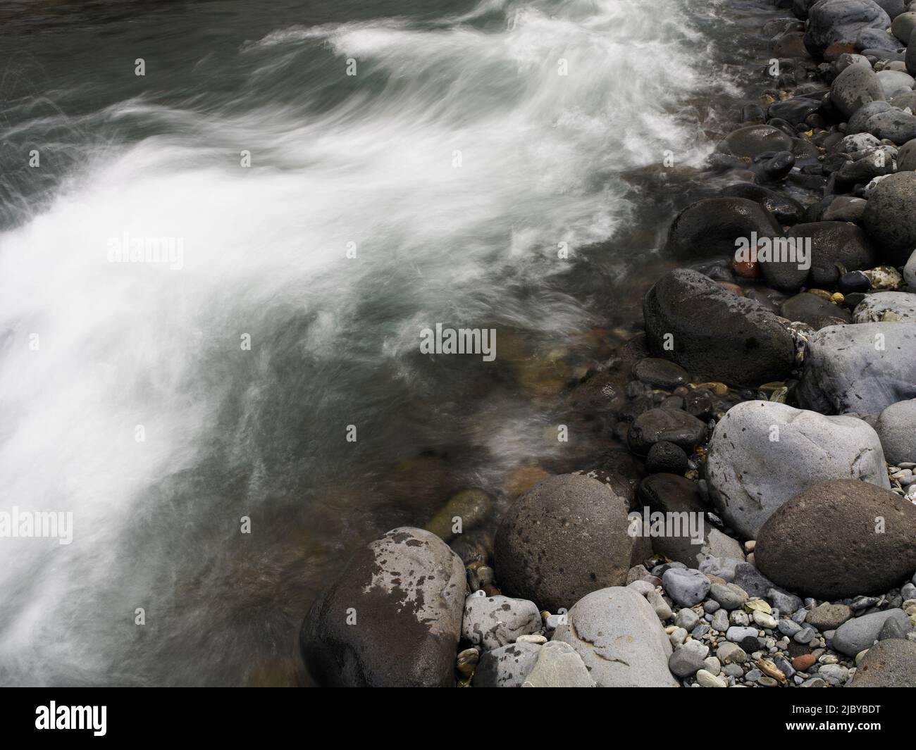Fast flowing river over rocky river bed Stock Photo - Alamy