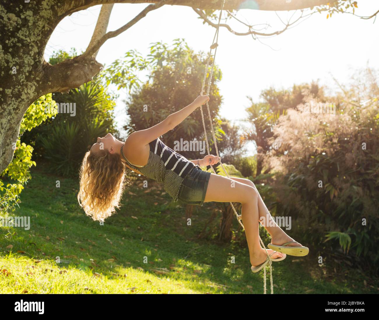 Child swinging on rope hi-res stock photography and images - Alamy