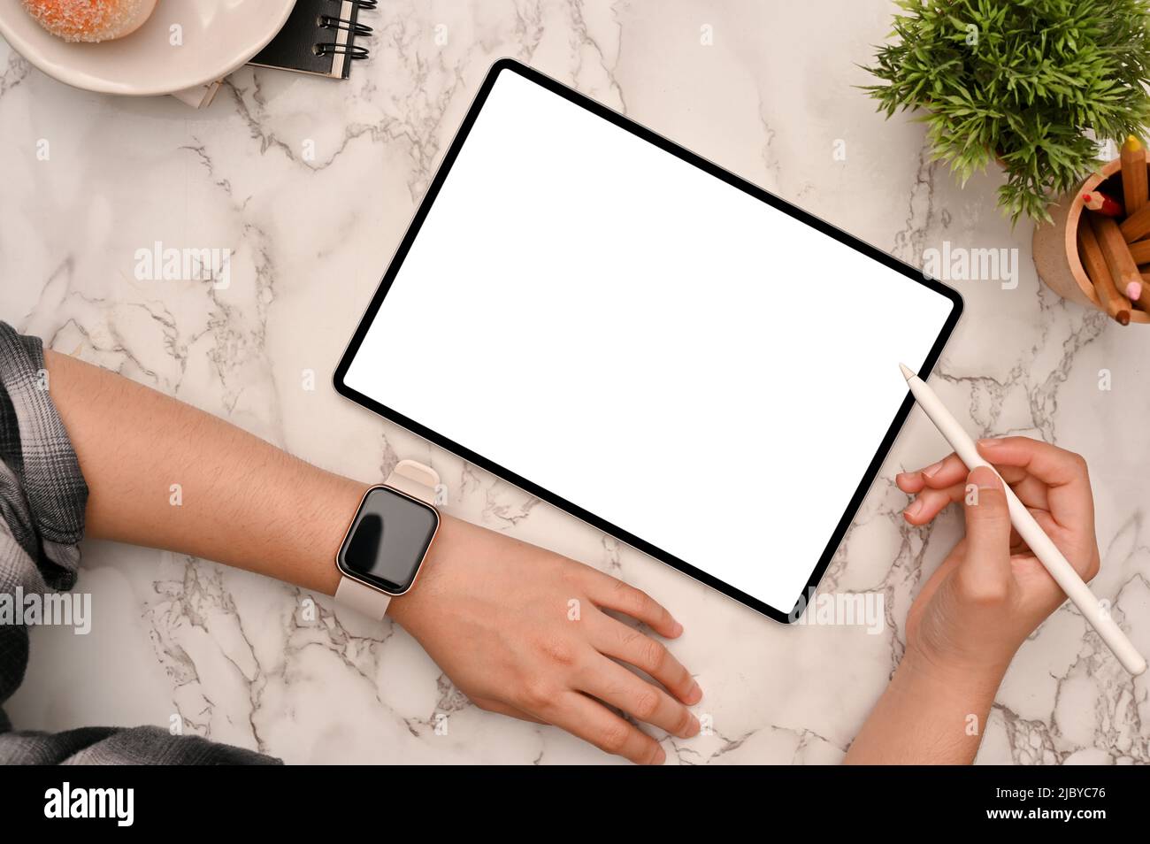 A hipster female freelancer using digital tablet touchpad in her modern ...