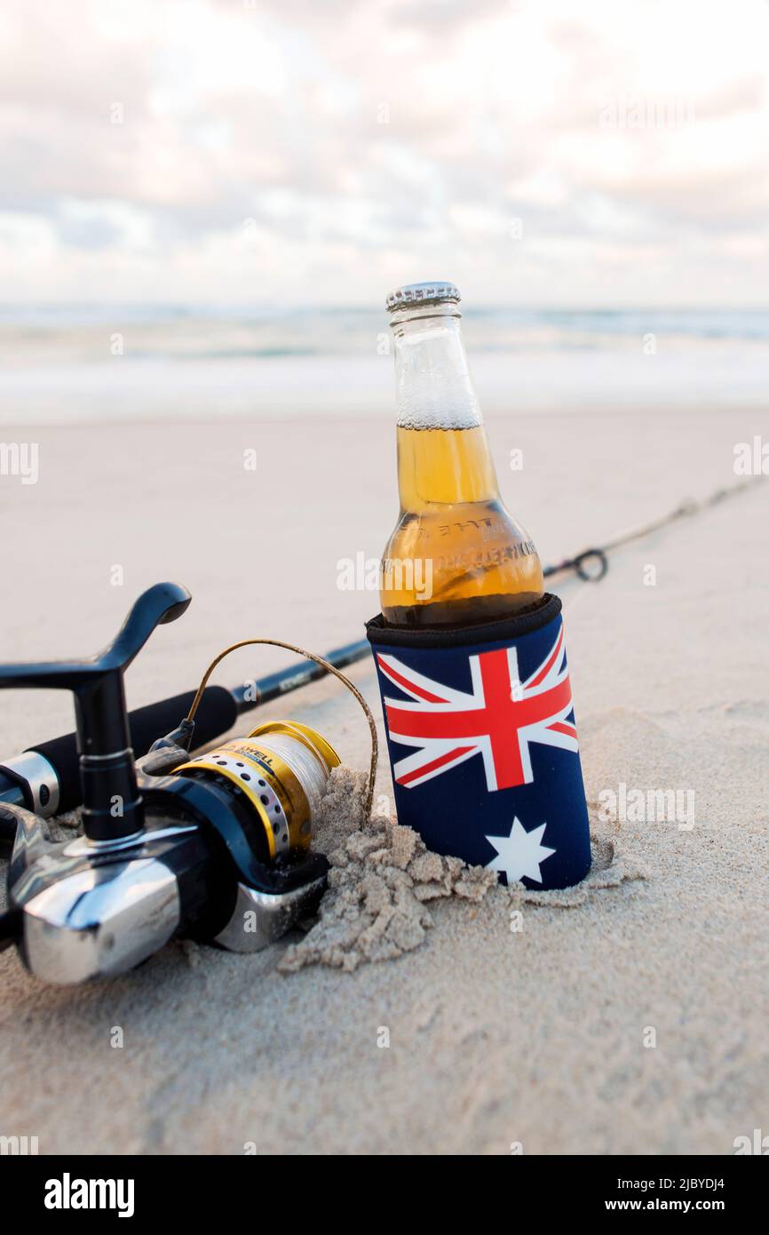 Beer in stubbie holder with Australian Flag next to Fishing rod on the ...