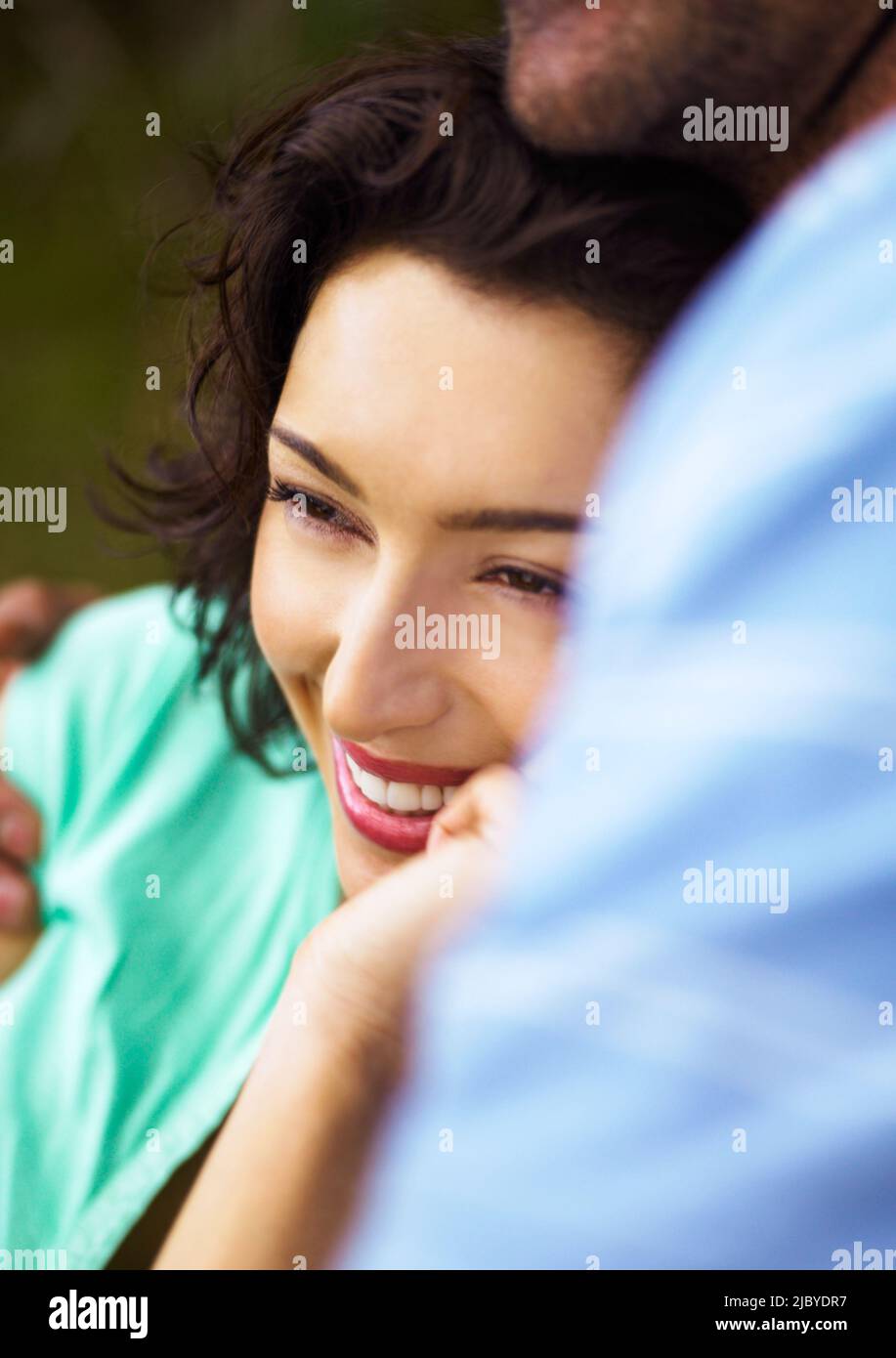 Woman smiling while being embraced by man Stock Photo - Alamy