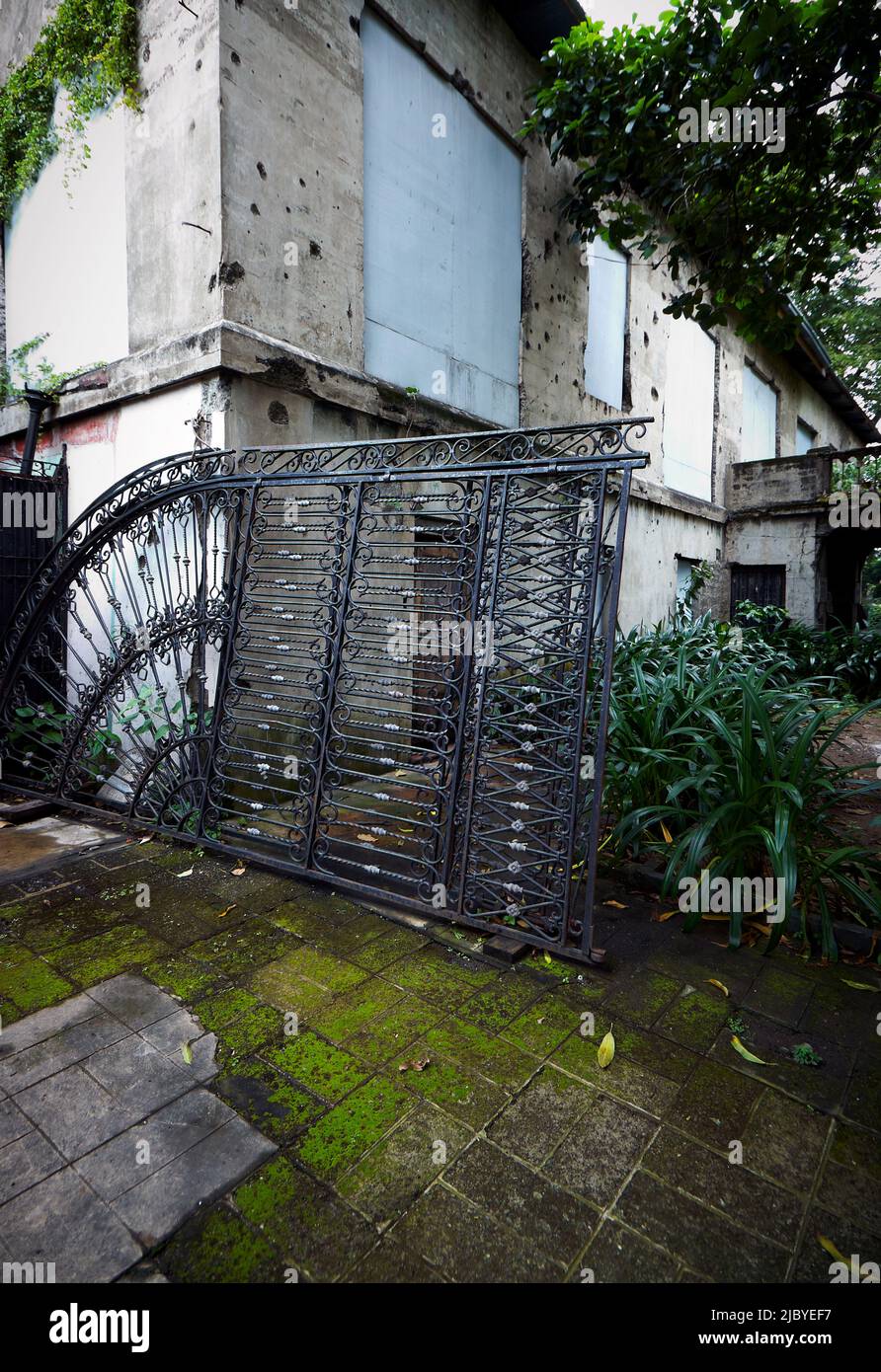 Big arched iron gates leaning against old building in Manila ...