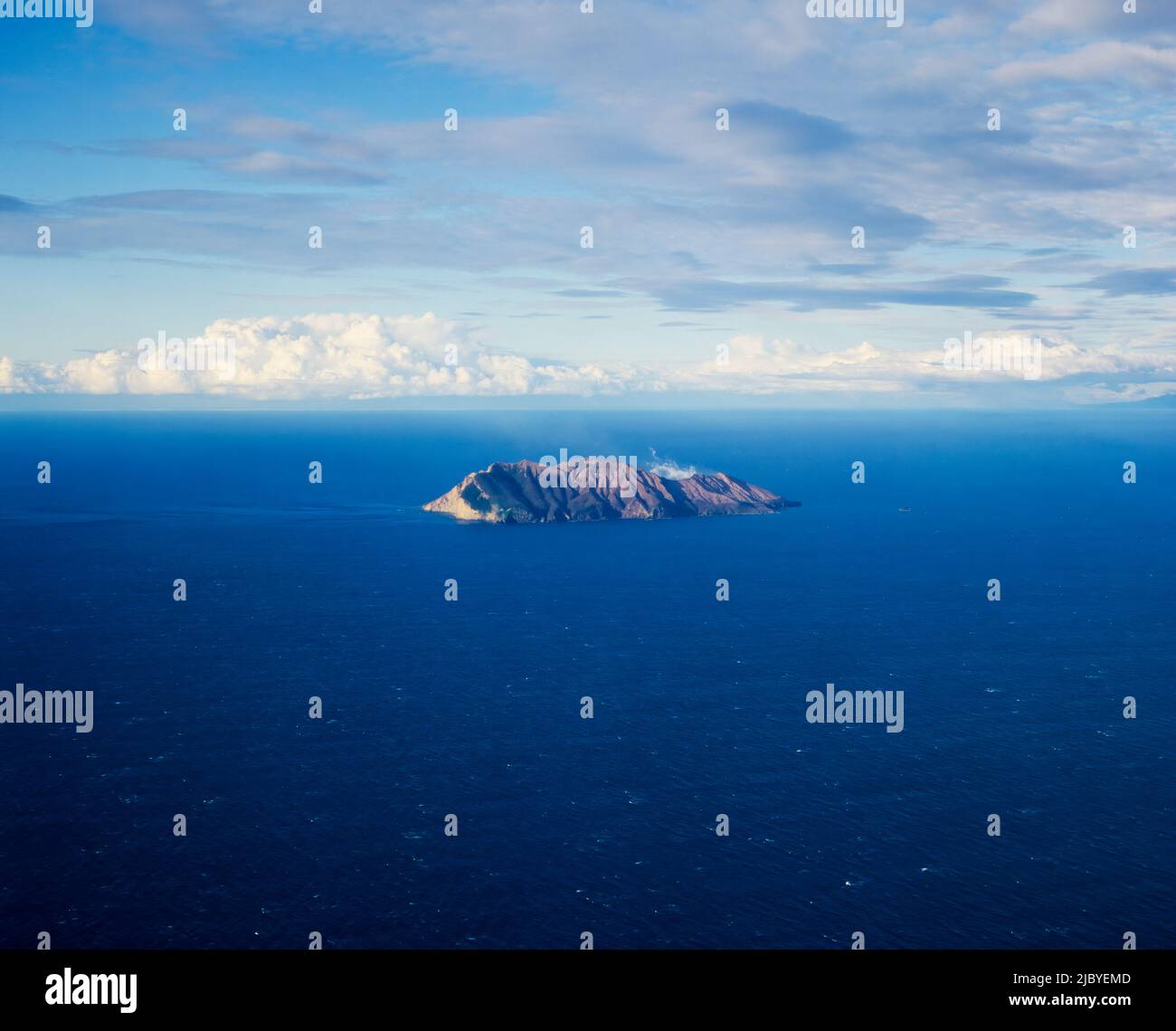 Aerial of White Island - Volcanic Island surrounded by blue ocean and ...