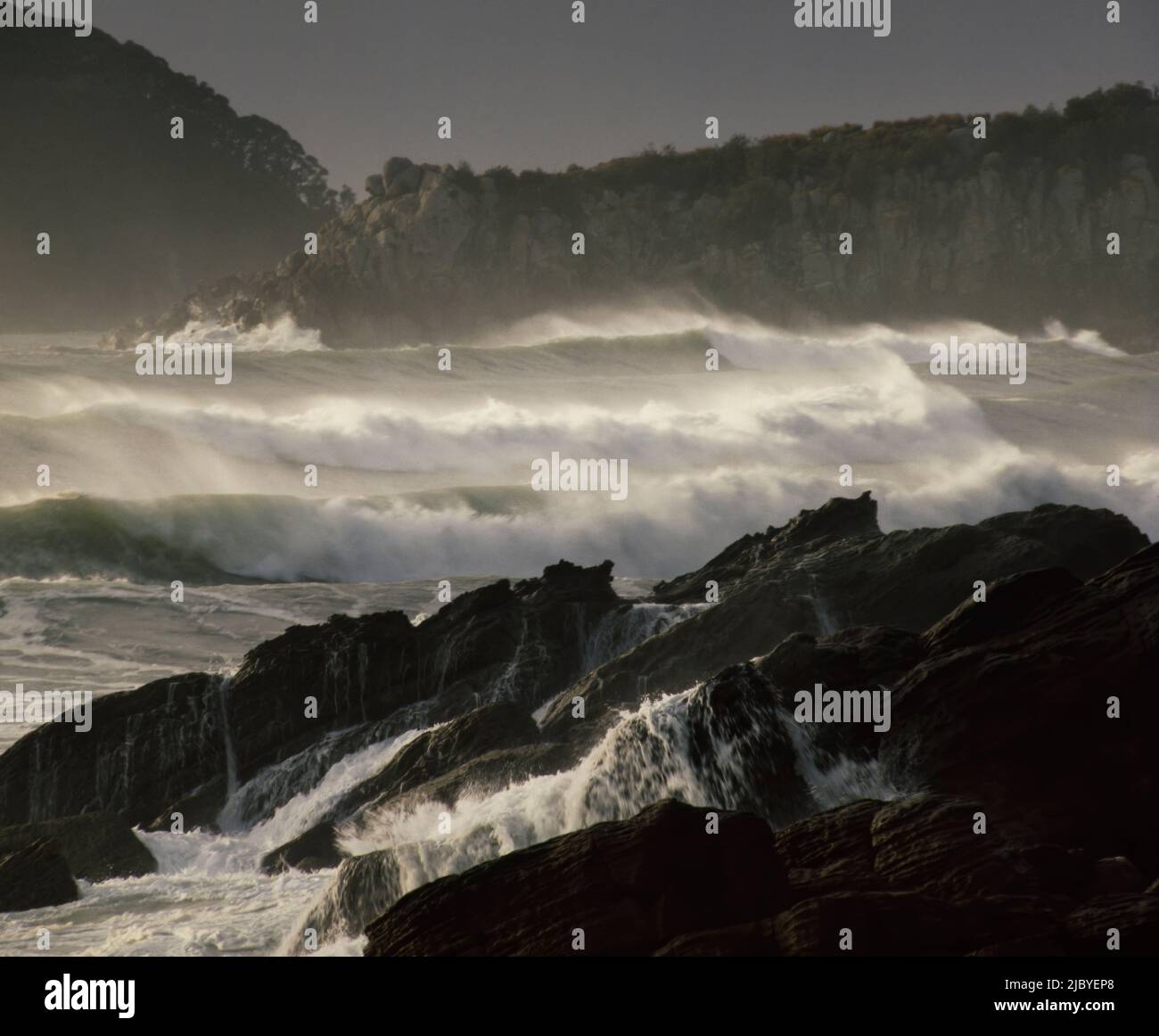 Large waves rolling into shore and crashing over rocky coastline Stock Photo - Alamy
