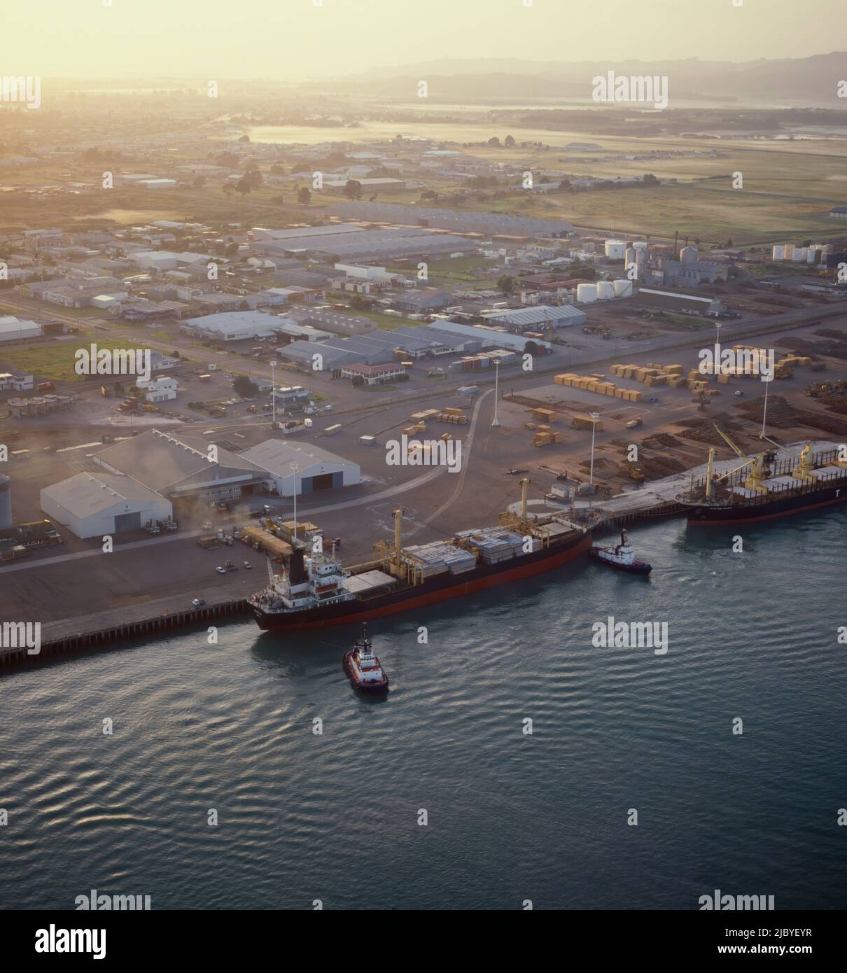Aerial of pilot boats guiding cargo ship into port Stock Photo - Alamy