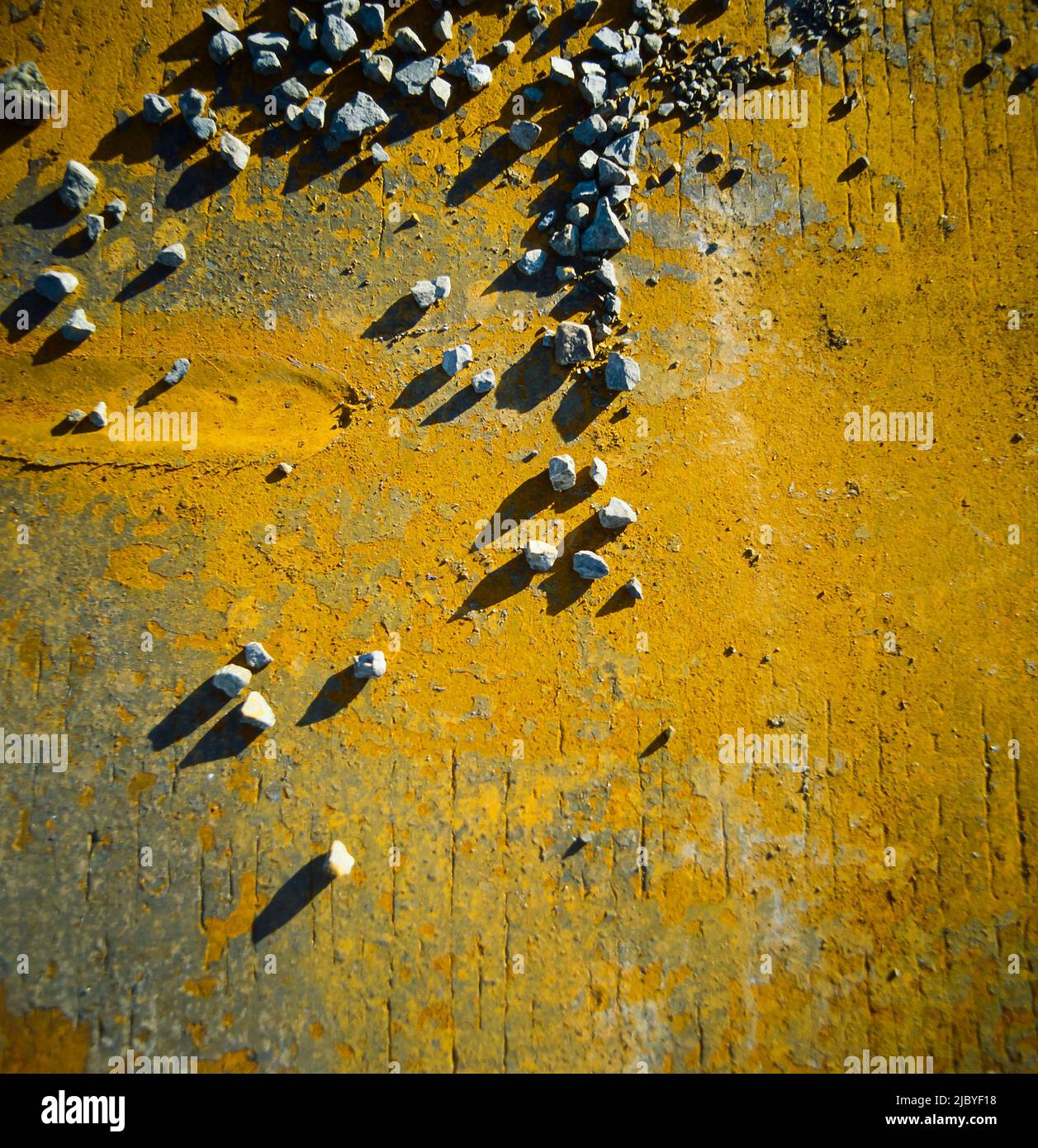 Gravel scattered on rusty steel Stock Photo - Alamy