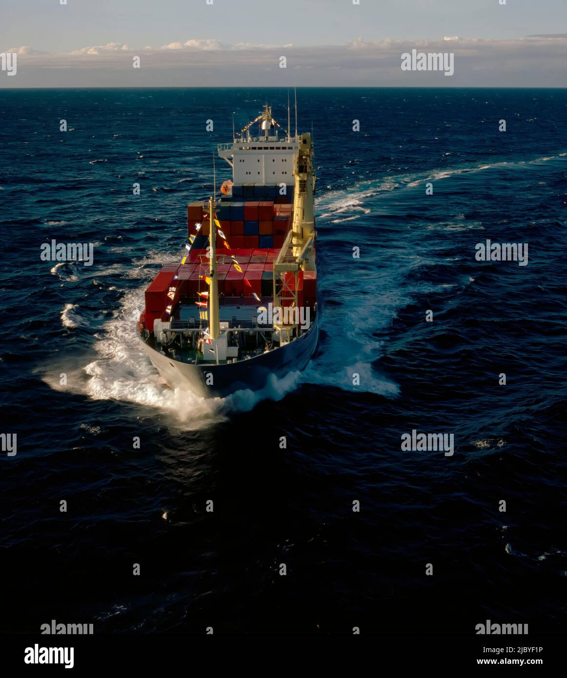 Cargo Ship loaded with containers moving through water Stock Photo - Alamy