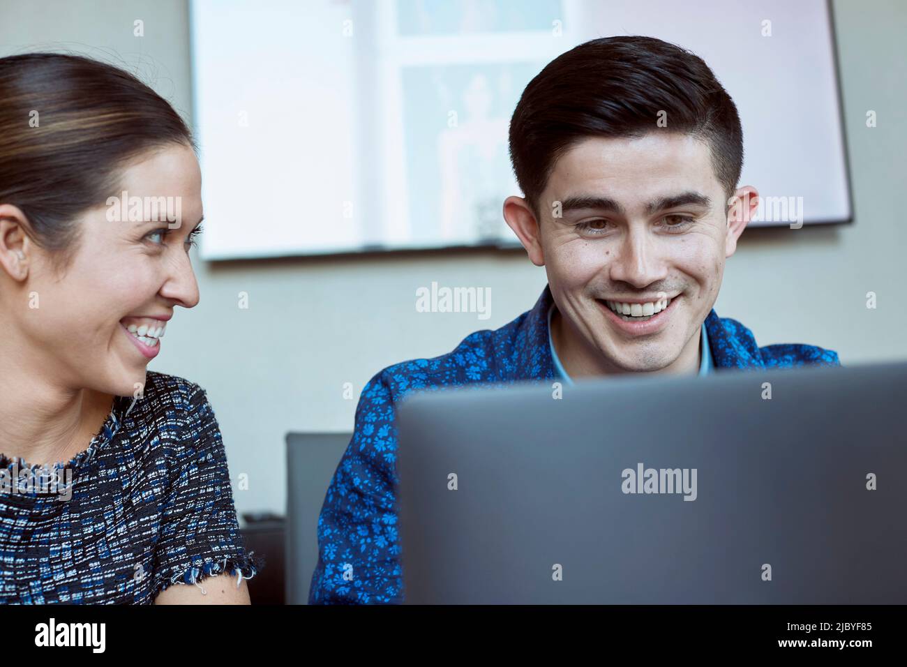 Business people gathered around laptop hi-res stock photography and ...