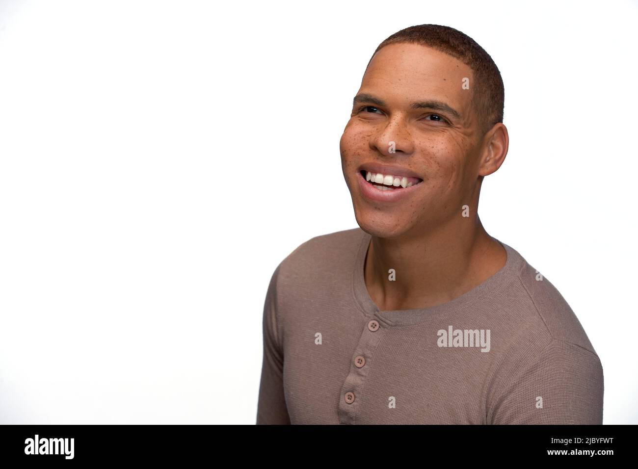 Portrait of young black man looking slightly off camera smiling Stock ...