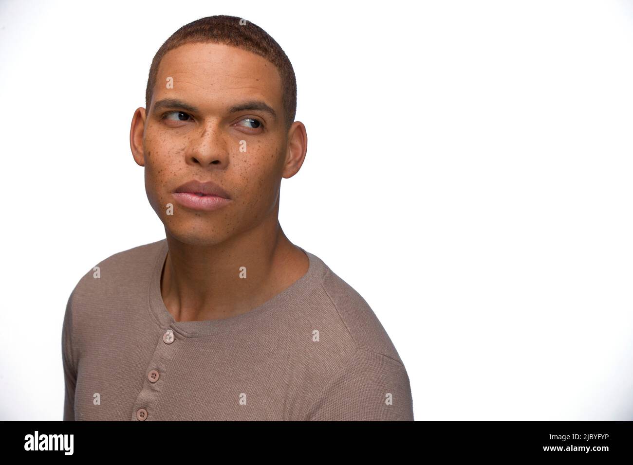 Portrait of young black man looking off camera Stock Photo - Alamy