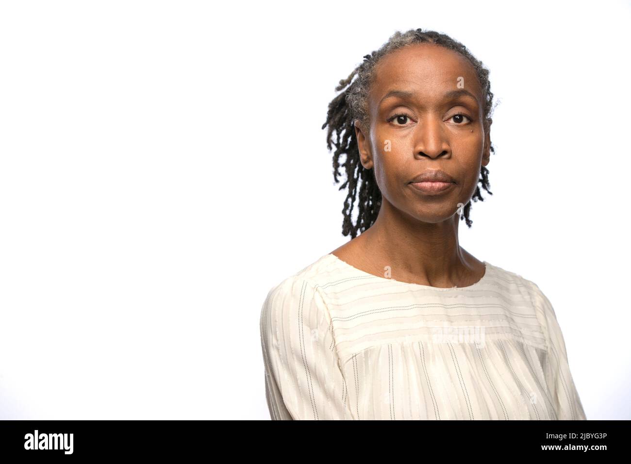 Portrait of middle aged black woman looking at camera with straight ...