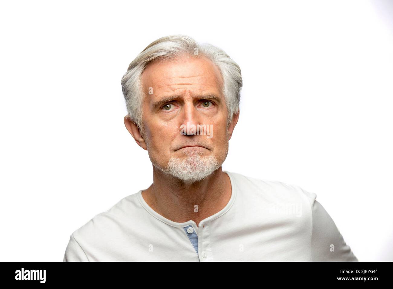 Portrait of middle aged white man with grey hair looking off camera ...