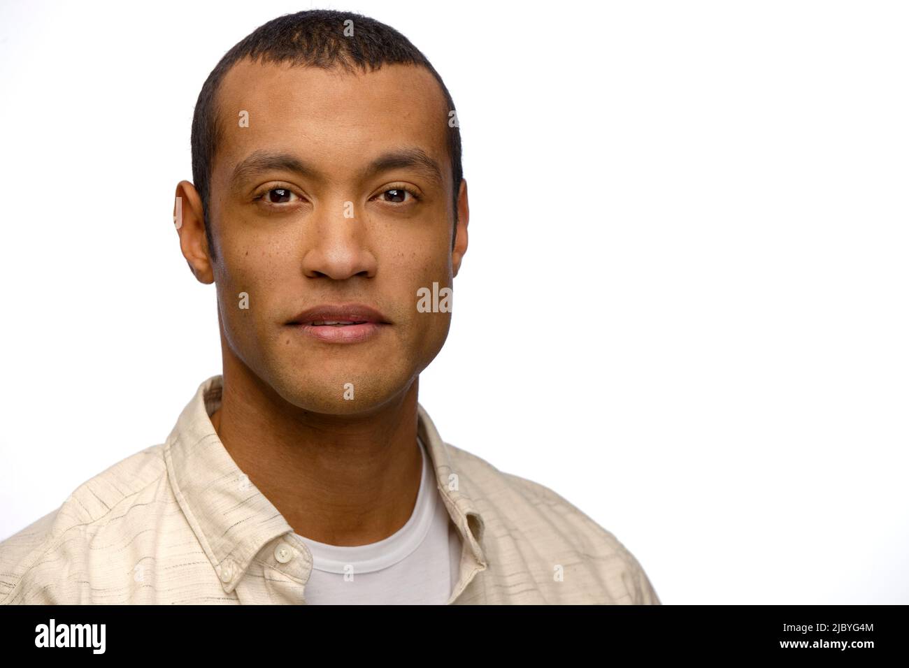 Portrait of young black man looking at camera with straight face Stock ...