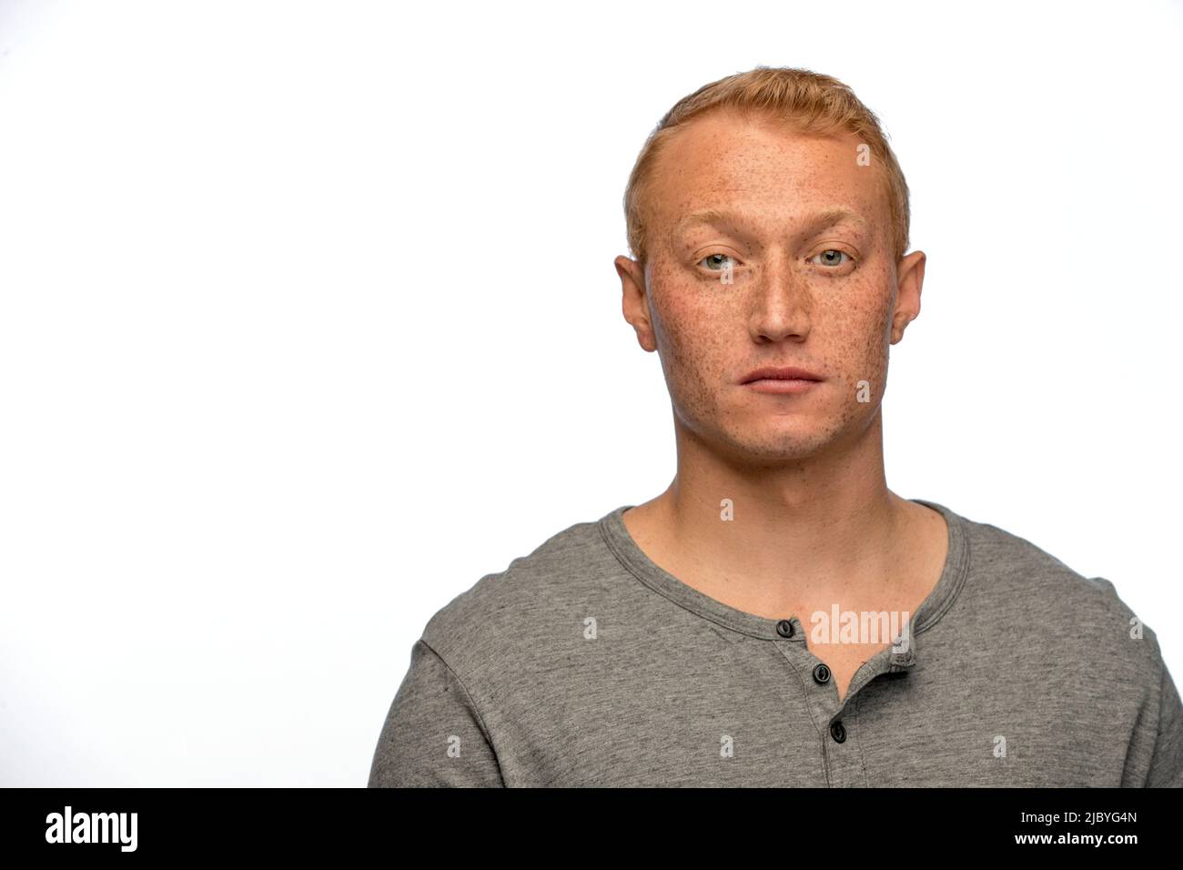 Portrait of young man looking off camera with straight face Stock Photo ...