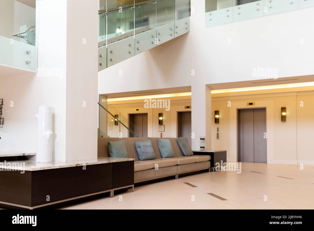 Empty Hotel lobby, with staircase and bank of elevators in background ...