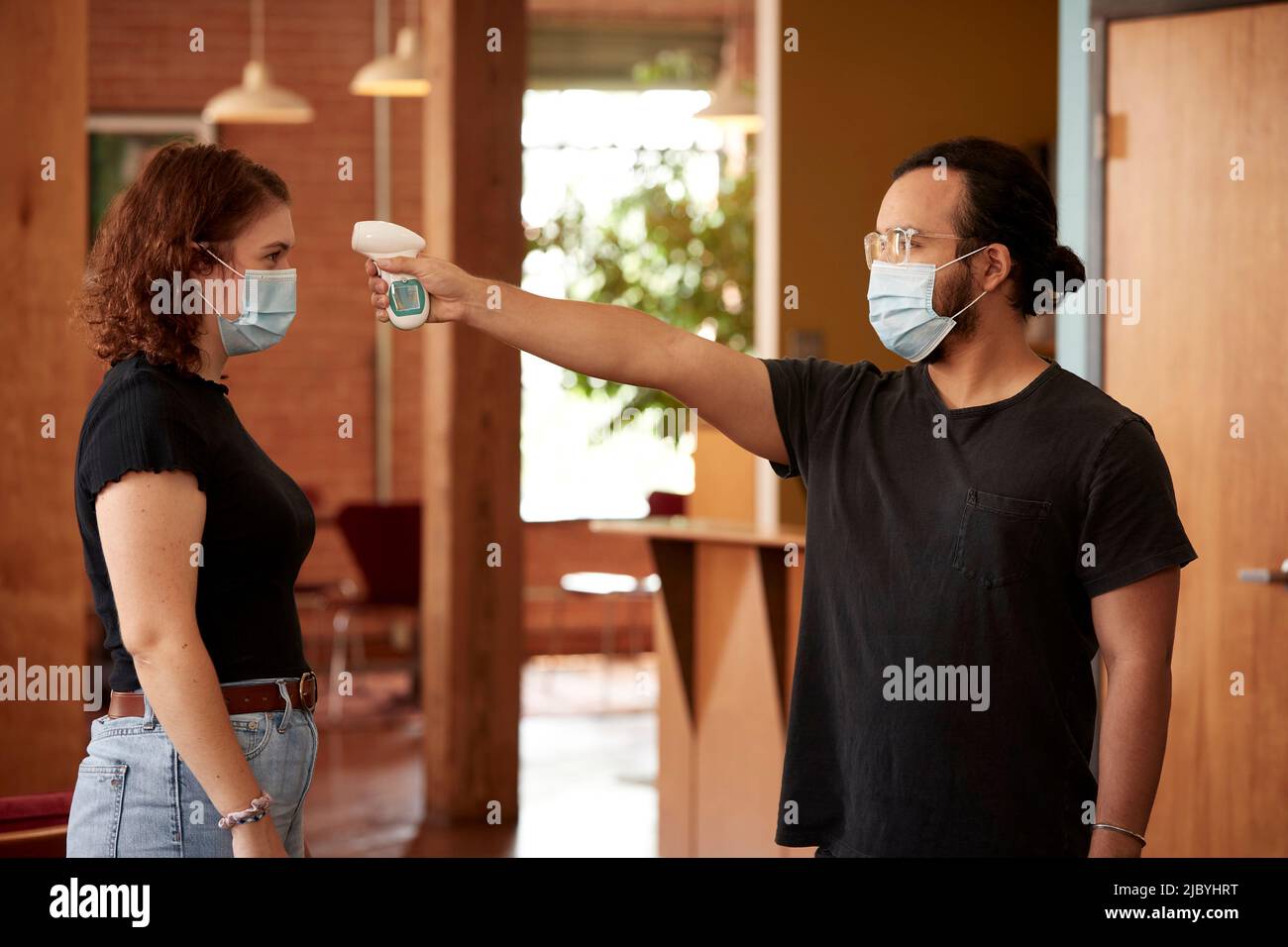 Young caucasian female wearing black t shirt and face mask, having ...