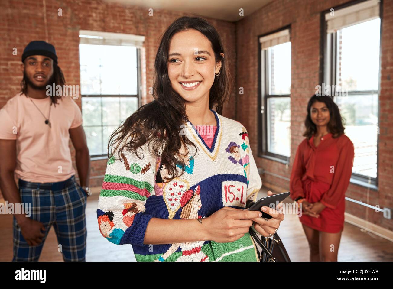 Group of friends in empty loft space, socially distanced group photo ...
