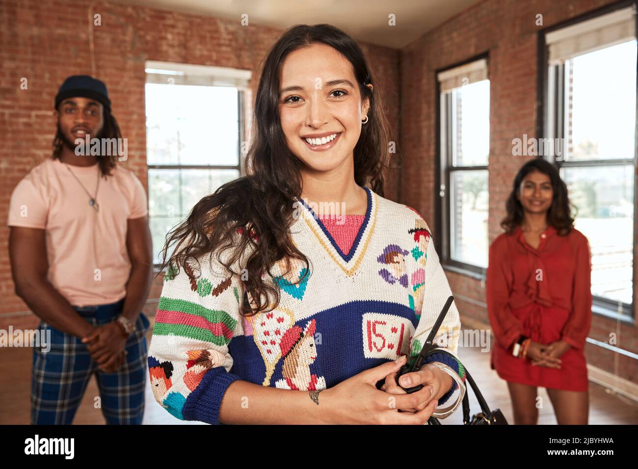 Group of friends in empty loft space, socially distanced group photo ...