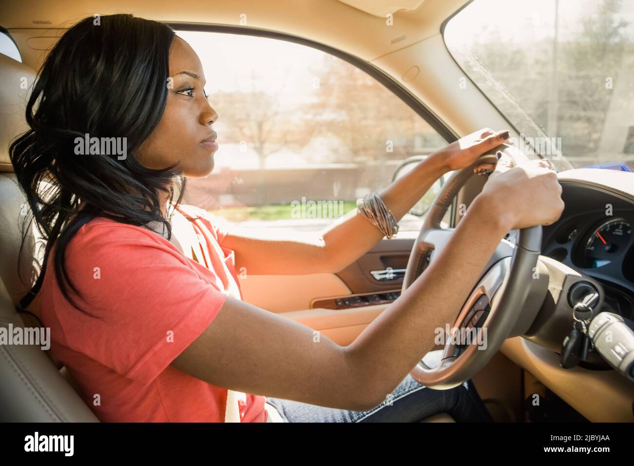 African American woman driving car Stock Photo - Alamy