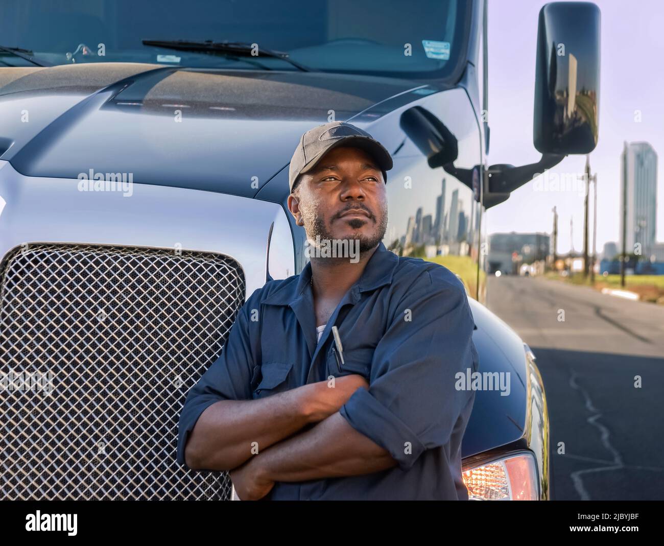 Serious man standing near semi-truck Stock Photo - Alamy