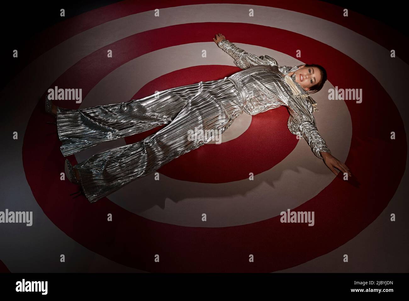 High angle 3/4 portrait of a woman laying on large hand painted Bulls ...