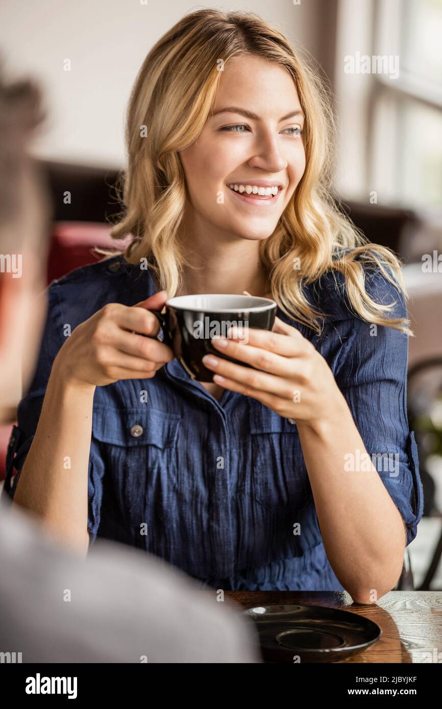 Caucasian couple drinking coffee together Stock Photo - Alamy