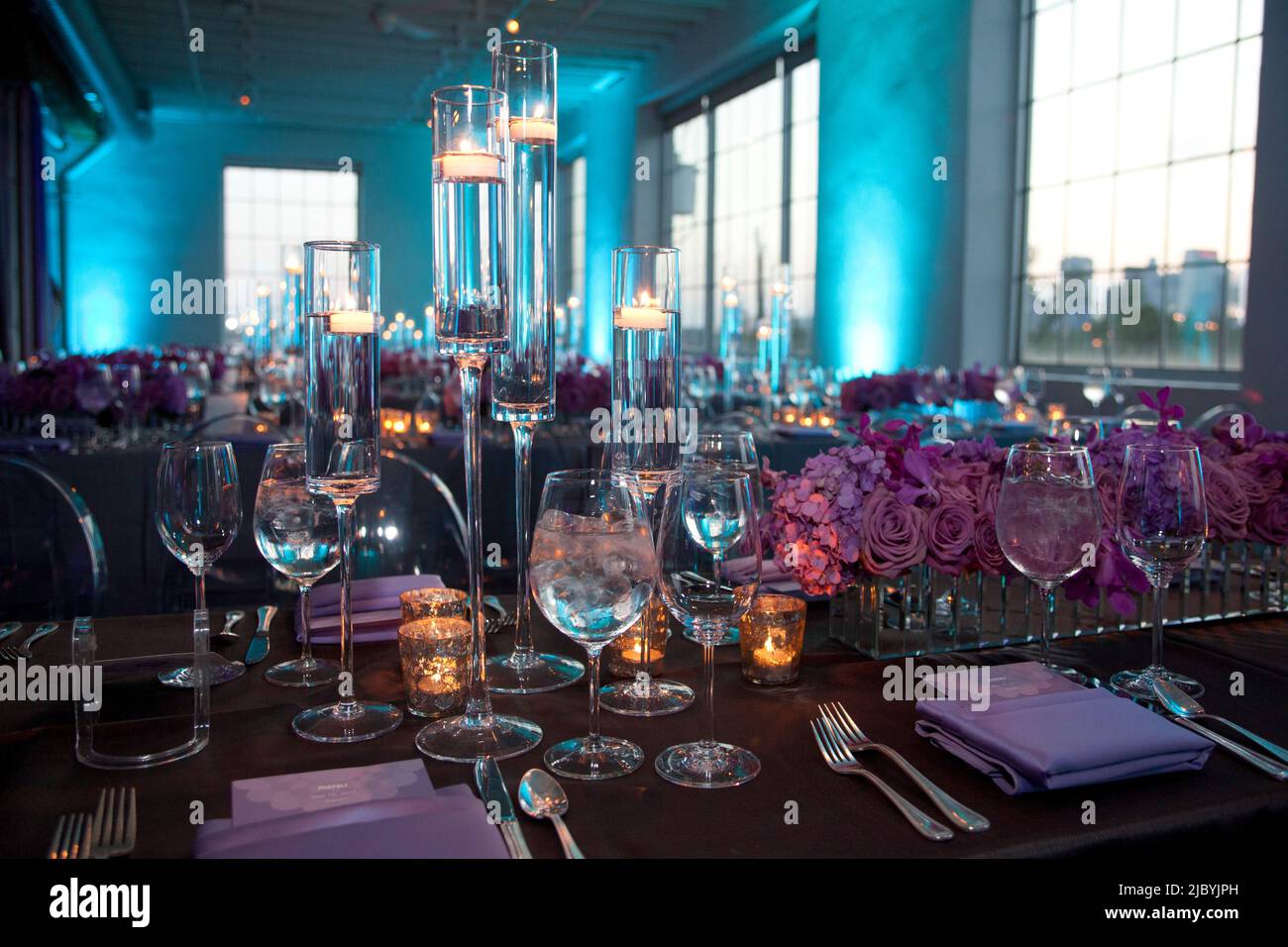 Low angle wide empty shot of table setting at a formal party at dusk ...
