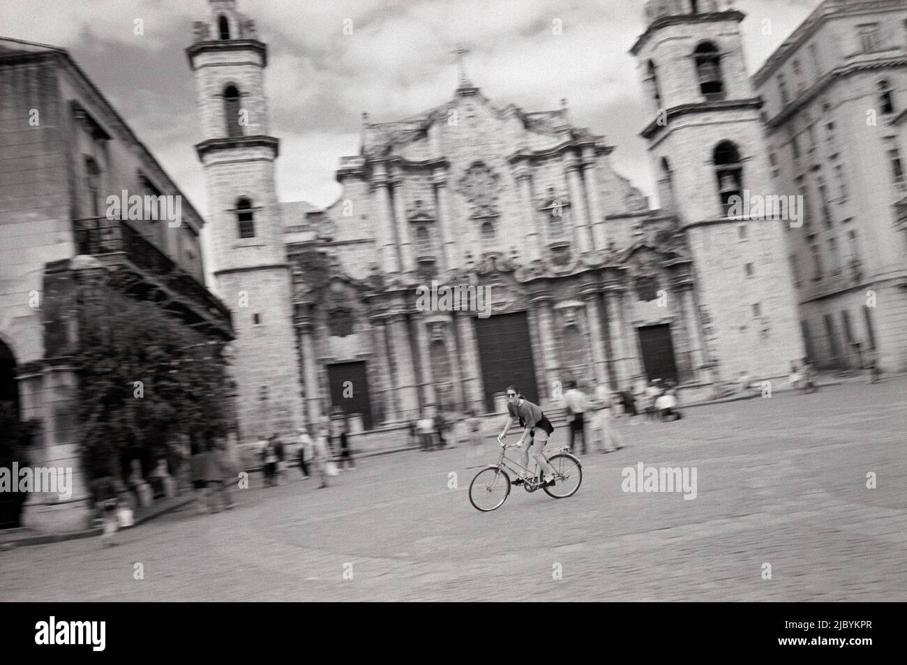 Bicyclist crossing town square Stock Photo - Alamy
