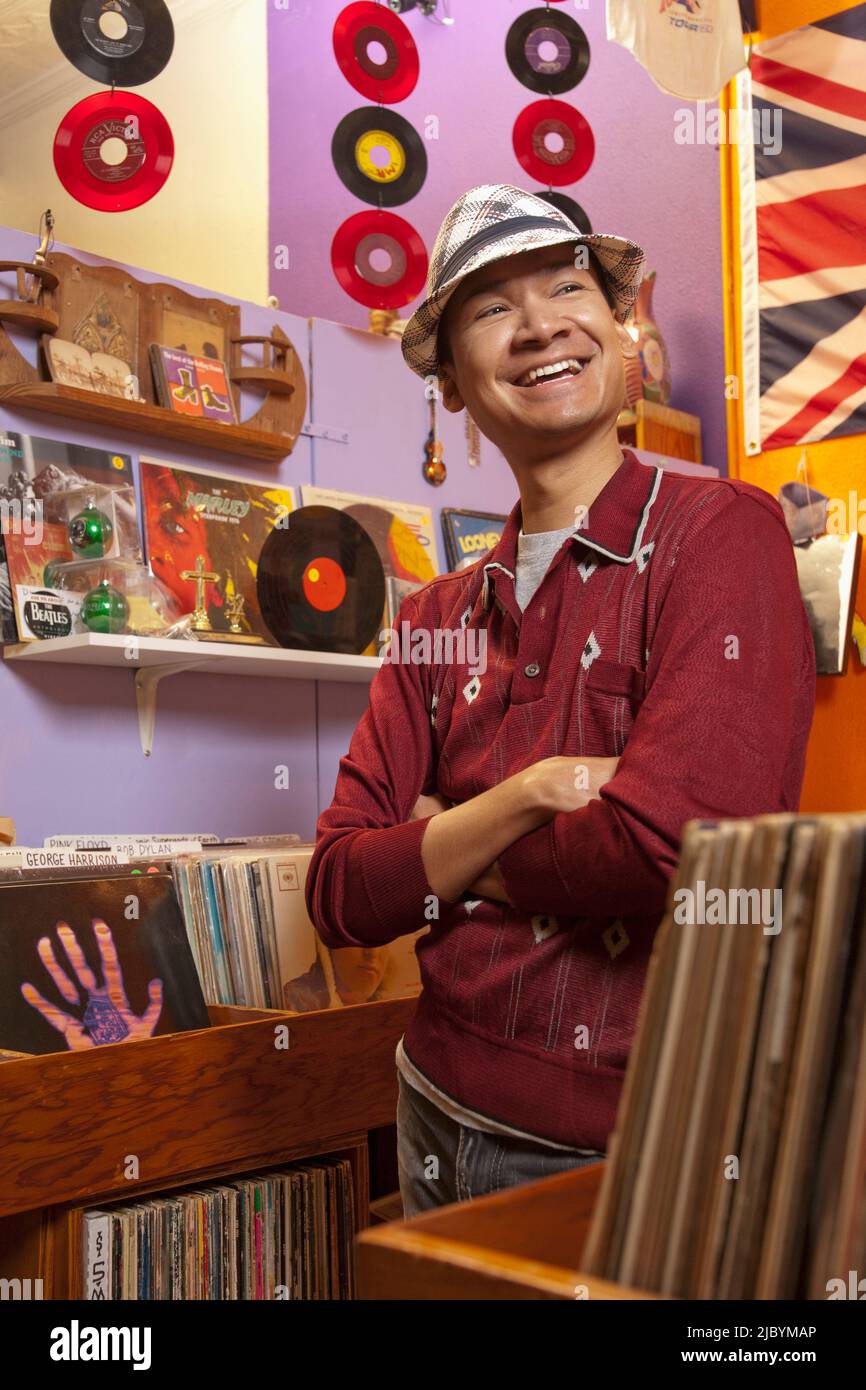 Malaysian owner in record store Stock Photo - Alamy