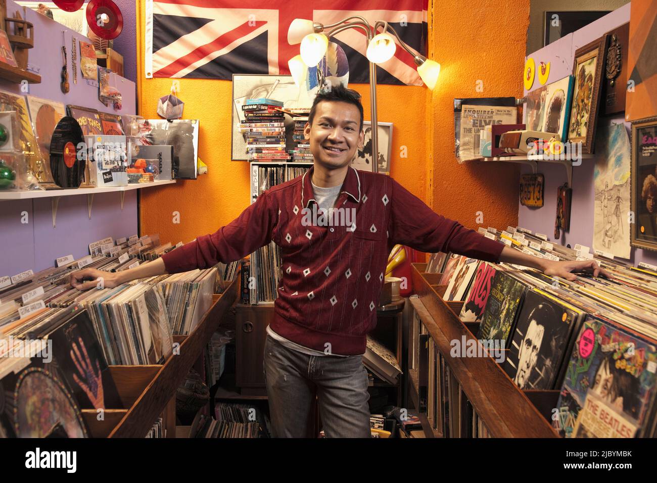 Malaysian owner in record store Stock Photo - Alamy