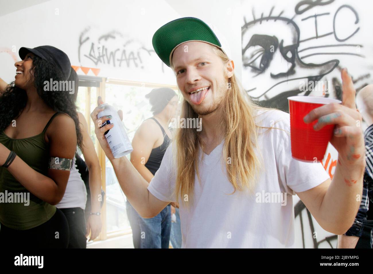 People tagging walls with graffiti Stock Photo - Alamy