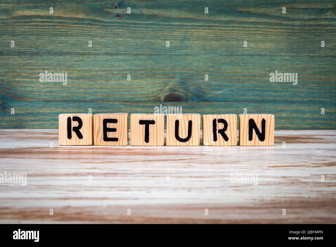 Return. Word from wooden blocks on a green and white background Stock ...